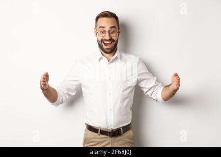 Amazed businessman showing big object, describe something large and ...