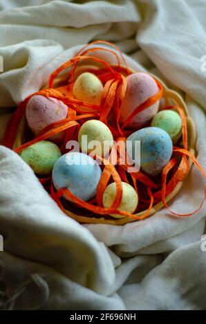 Close up of colorful Easter eggs in a basket Stock Photo - Alamy