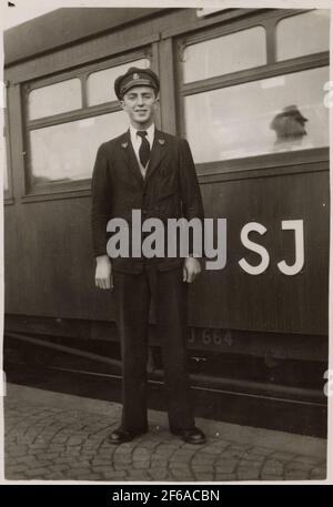 Knut Claesson in front of a state railways, SJ passenger car with ...