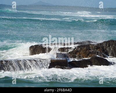 Wave splashing over and running into rock formation in the Atlantic ...