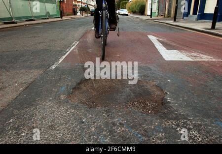 Bikes and Potholes 2/2/07 Tom Pilston Stock Photo - Alamy