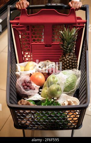 Eco friendly zero waste supermarket vendor assisting elderly client ...