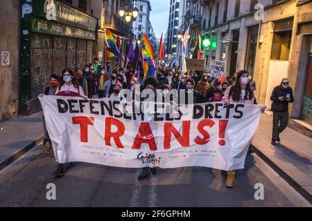 Protesters hold a banner that says, trans childhood and youth. It ...