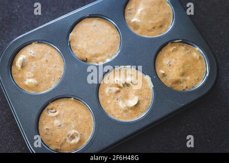 vegan savoury muffins with olives and nutritional yeast in baking tray ...