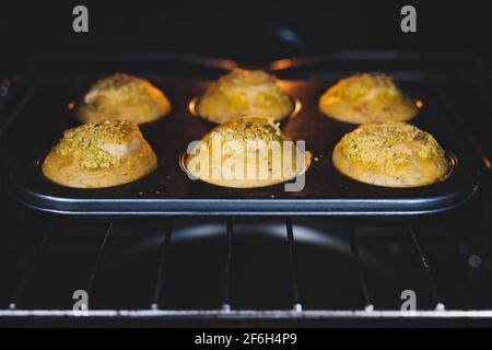 vegan savoury muffins with olives and nutritional yeast in baking tray ...