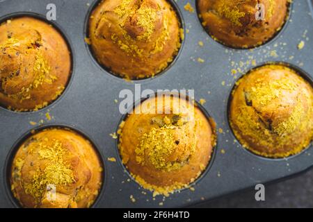 vegan savoury muffins with olives and nutritional yeast in baking tray ...