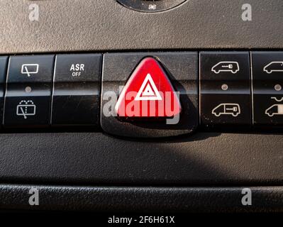 Red triangular car alarm button on the dashboard. Car alarm. Red button ...