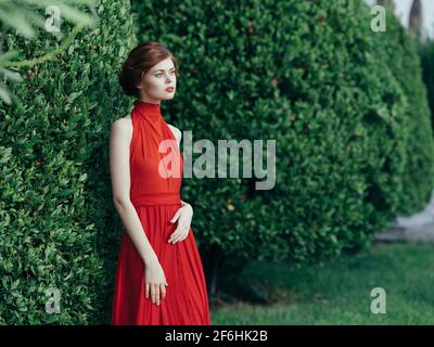 Beautiful lady red dress green bush outdoors walk luxury princess Stock ...