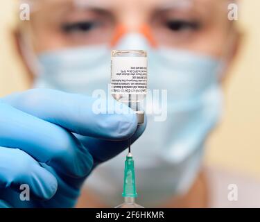 Covid-19 vaccine with syringe ready to implement face mask and latex ...