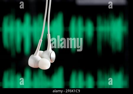 headphone hanging with sound waves on blurred digital background Stock ...