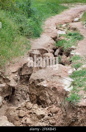 Green grassy slope with soil erosion Stock Photo - Alamy