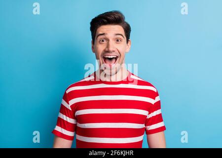 Photo of impressed funny guy dressed white shirt playing modern gadget ...