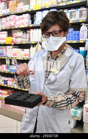 Pharmacist holds up a vial of Astra Zeneca Covid- 19 vaccine in the ...