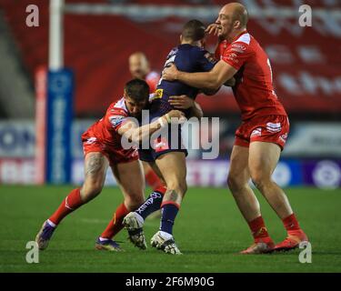 Greg Minikin (3) of Hull KR is tackled by Benjamin Jullien (15) of ...