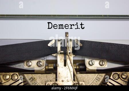 Demerit symbol. The word 'demerit' typed on retro typewriter. Business ...