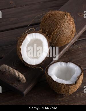 split coconut on wooden planks. Coco, ripe palm fruit. outside of the ...