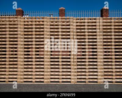 Big tall stacks of pallets at pallet recycling business in Michigan ...