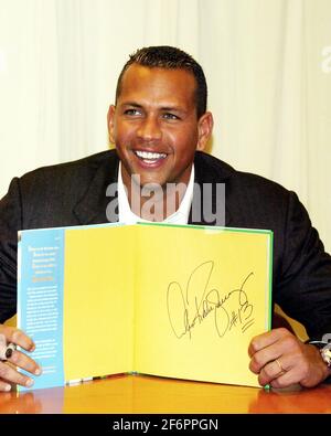 Alex Rodriguez ("A-Rod") poses for pictures before signing copies of ...