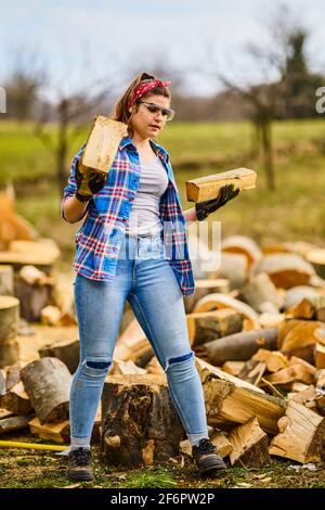 A Happy young woman collecting firewood Stock Photo - Alamy