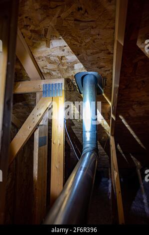 Attic view of installation of a galvanized vent pipe through a roof ...