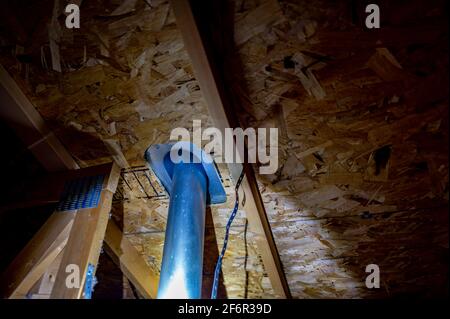 Attic view of installation of a galvanized vent pipe through a roof ...