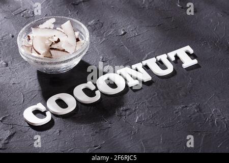 Grated coconut - Cocos nucifera. Word coconut in letters Stock Photo ...