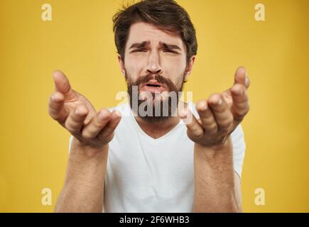 Emotions model irritability sad face yellow background man Stock Photo ...