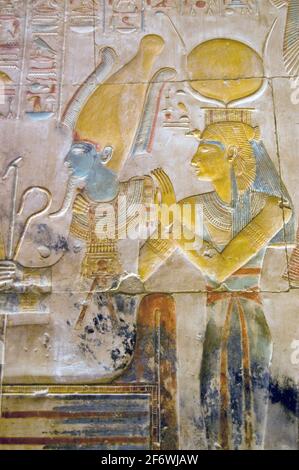 The Ancient Egyptian goddess Isis seated on a throne holding her ...