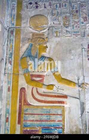 The goddess Isis, seated on a throne and holding a sceptre and ankh, in ...
