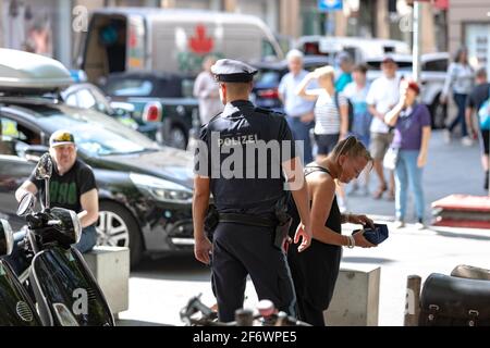 German policemen checking ID documents on the streets in Munich ...