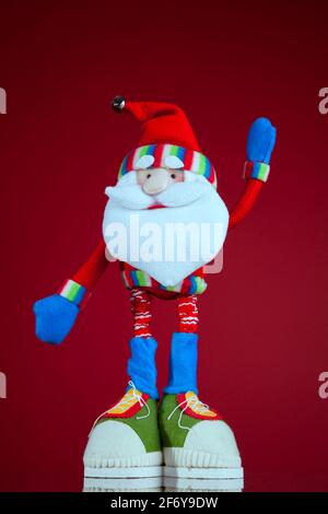 a Santa Clause Decoration over a Christmas wallpaper Stock Photo - Alamy