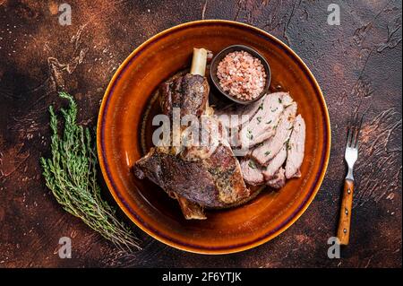 BBQ Roast Lamb mutton leg sliced on a rustic plate. Isolated on white ...