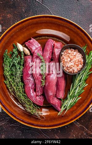 Uncooked lamb loin fillet, Mutton raw meat on butcher cleaver. Dark ...