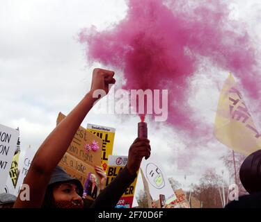 London, UK. 03rd Apr, 2021. A man speaking on the mobile phone walks ...