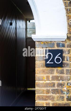 Houe number 26 on a yellow brick wall Stock Photo - Alamy