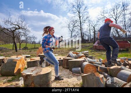 Wife chasing her husband with chainsaw, fooling around Stock Photo - Alamy
