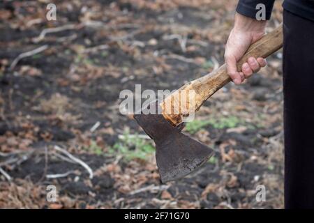 A man holds an ax in his hands against on black background Stock Photo ...