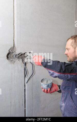 The electrician will plaster holes and channels for sockets and wires ...