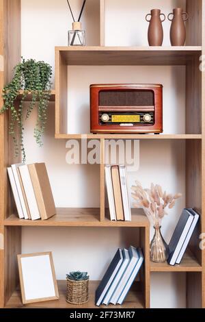 Book shelf with retro radio receiver in room, closeup Stock Photo - Alamy