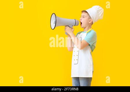 Little chef with megaphone on color background Stock Photo - Alamy