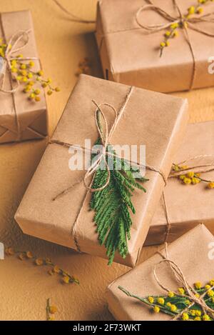 Gift boxes with mimosa branches on light background Stock Photo - Alamy