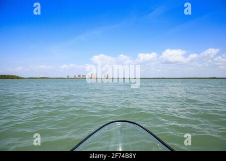 Clear kayak forges through the waterway of Lovers Key in Bonita Springs ...