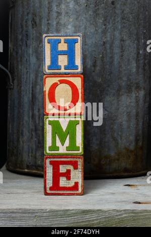 "Home" spelled in vintage wooden blocks with gardening background Stock ...