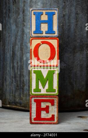 "Home" spelled in vintage wooden blocks with gardening background Stock ...