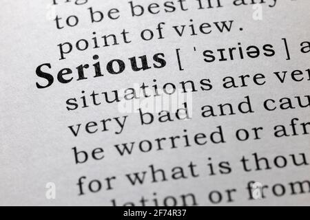 Fake Dictionary, Dictionary definition of serious Stock Photo - Alamy
