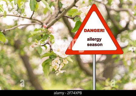 warning sign: danger allergy season against the background of peony ...
