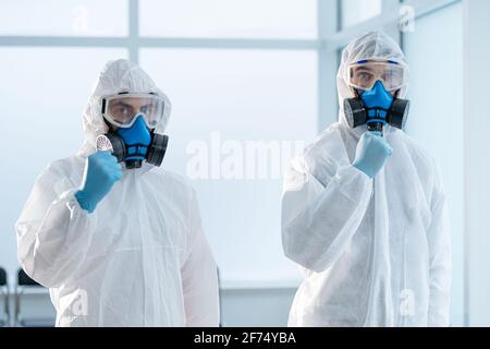 colleagues in biohazard suits standing in the lab Stock Photo - Alamy