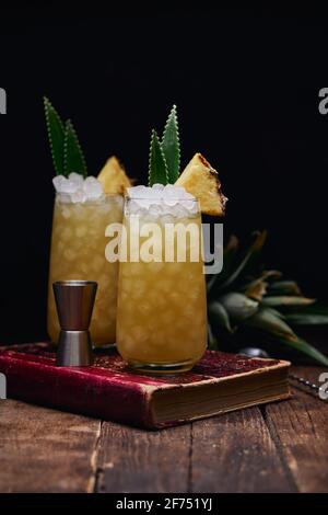 Glass with ice pieces on the wooden table. Ice starting to melt ...