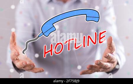 Hotline concept above the hands of a man in background Stock Photo - Alamy