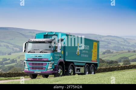 Lorry delivering a bulk load of animal feed to a dairy farm in North ...